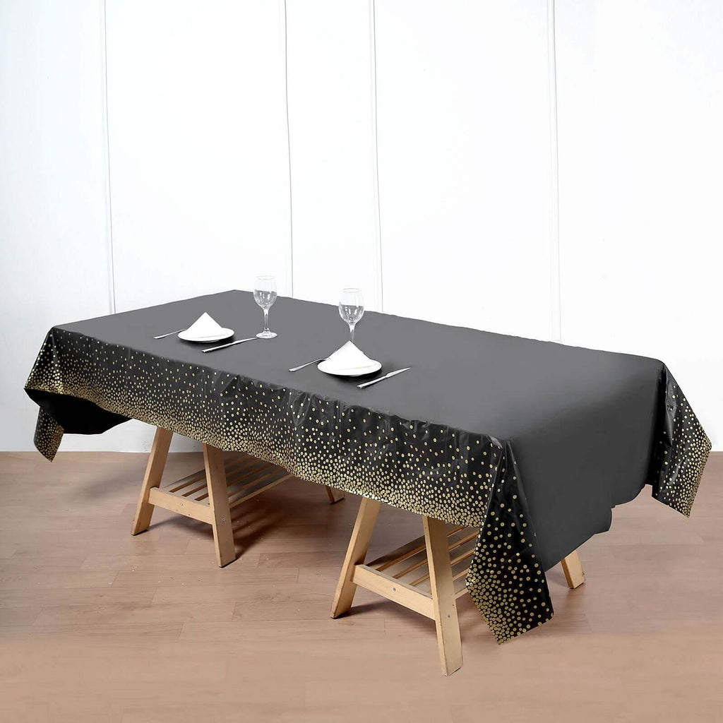 Plastic Rectangle Table Covers 54"x108" Black with Gold Confetti Dots | TableclothsFactory