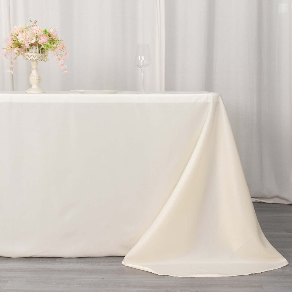 Polyester Oval Tablecloth 90"x132" Ivory | TableclothsFactory
